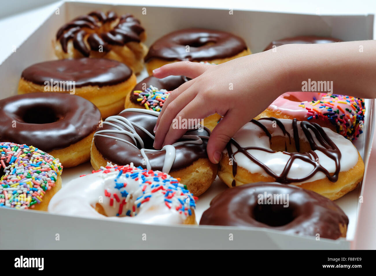 Donut in hand hi-res stock photography and images - Alamy