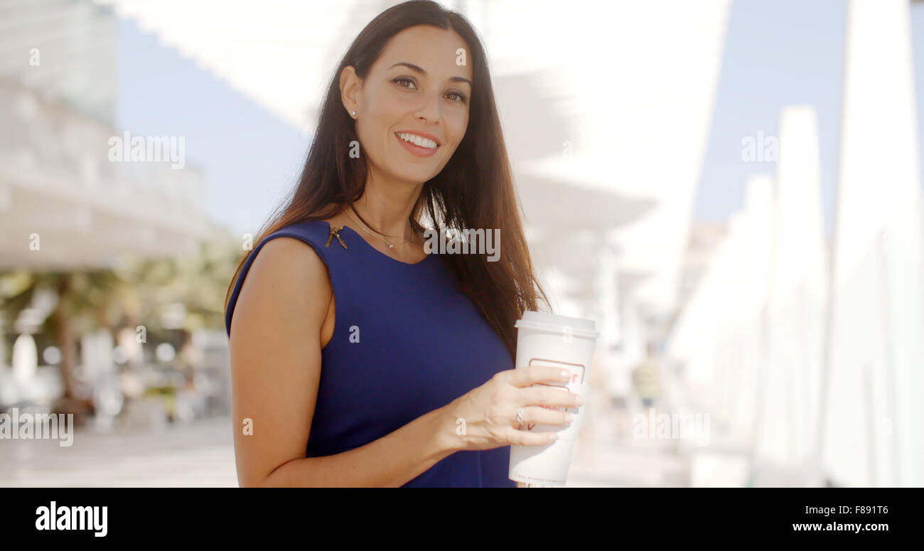 Attractive woman holding a large cup of coffee Stock Photo - Alamy