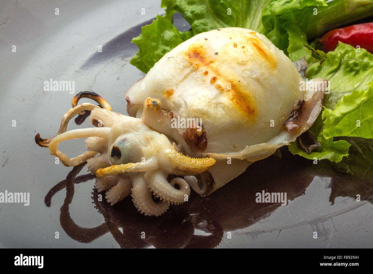 Grilled cuttlefish with salad and pepper Stock Photo - Alamy
