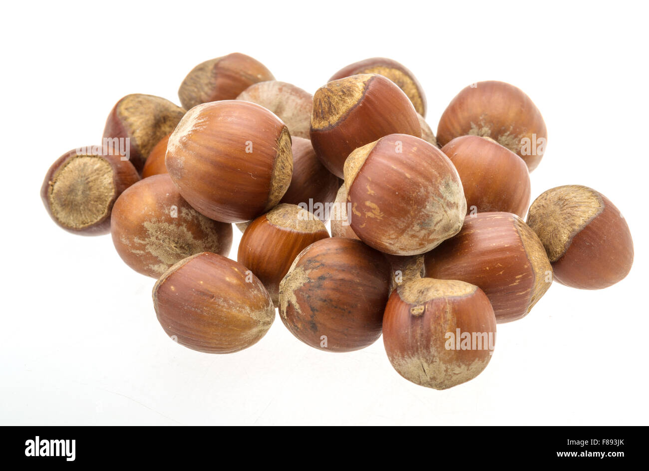 Hazelnut heap isolated on white background Stock Photo - Alamy