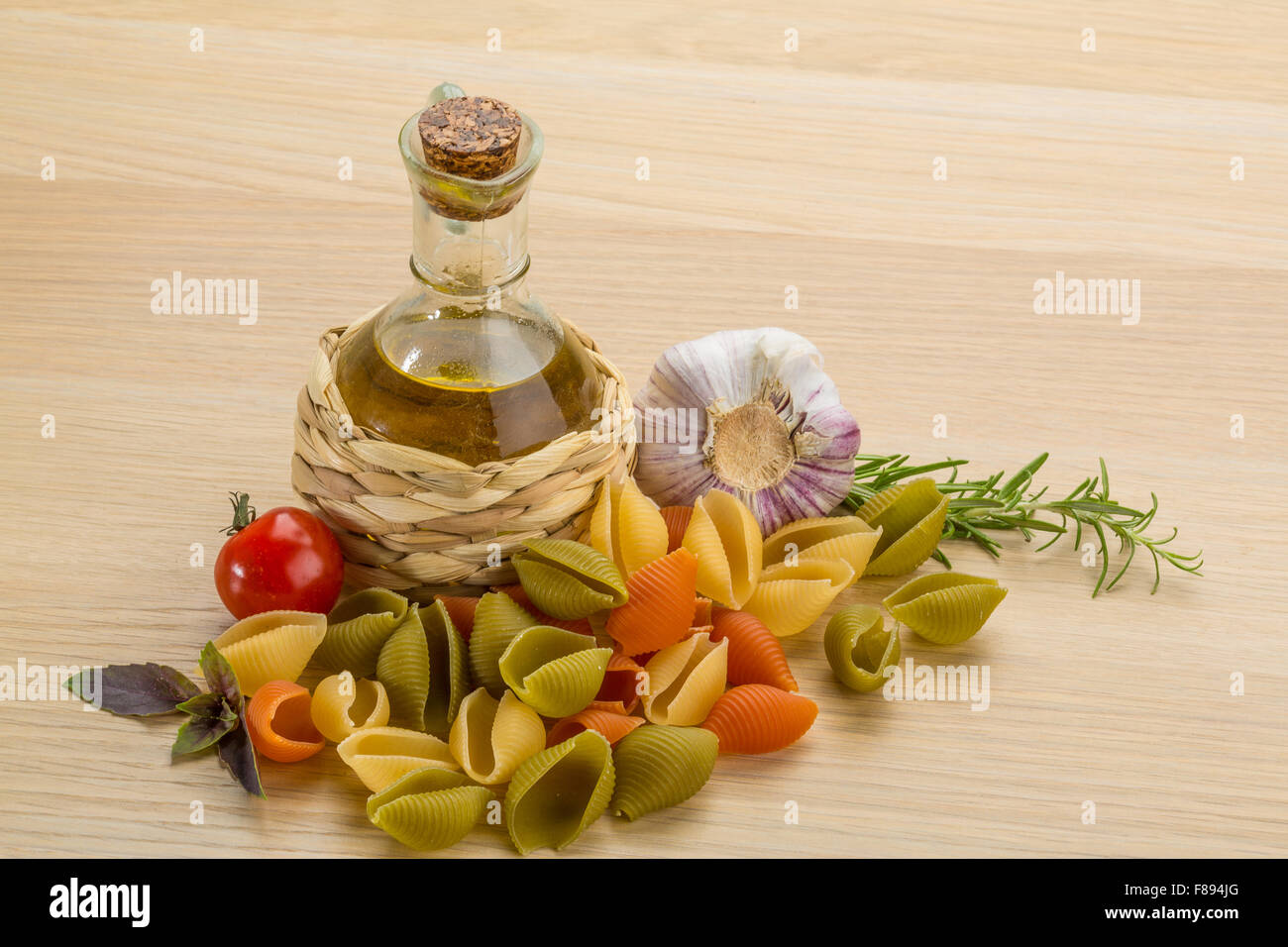 Raw macaroni - shell pasta with herbs Stock Photo - Alamy
