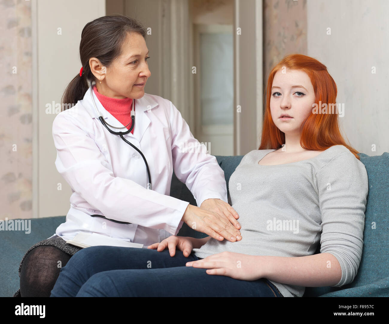 Doctor examining stomach girl hi-res stock photography and images - Alamy