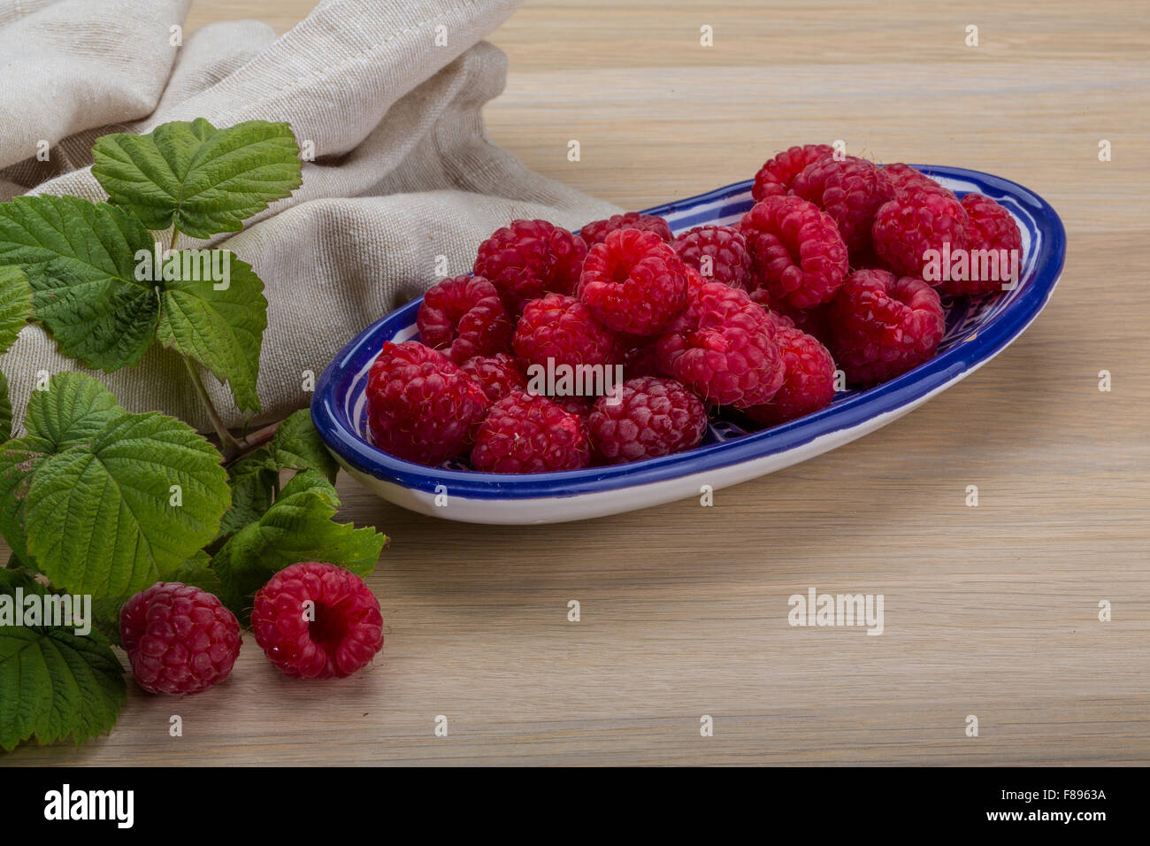 Fresh raspberry with leaf in the bowl Stock Photo - Alamy