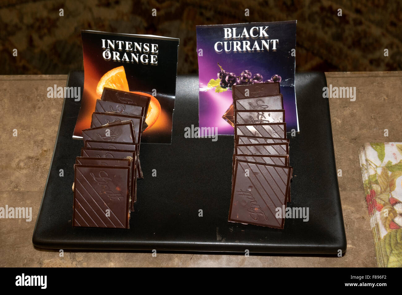 Table snack display of Intense orange and black current chocolate. St ...