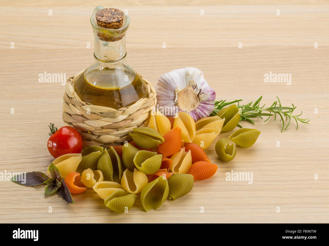 Raw macaroni - shell pasta with herbs Stock Photo - Alamy