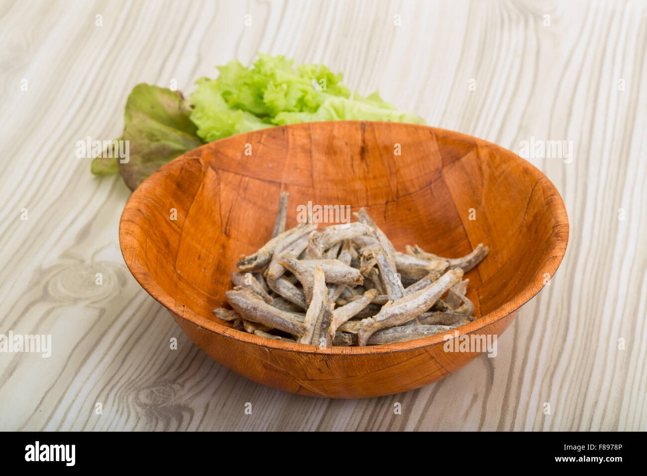 Dries anchovy - small fishes in the bowl Stock Photo - Alamy