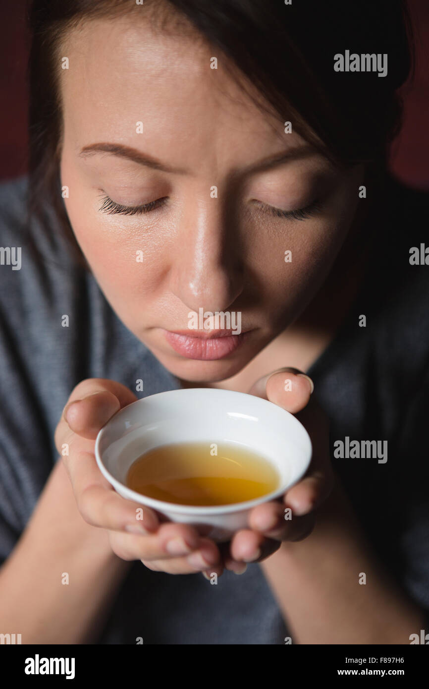 Closeup portrait of a young woman smelling tea Stock Photo - Alamy