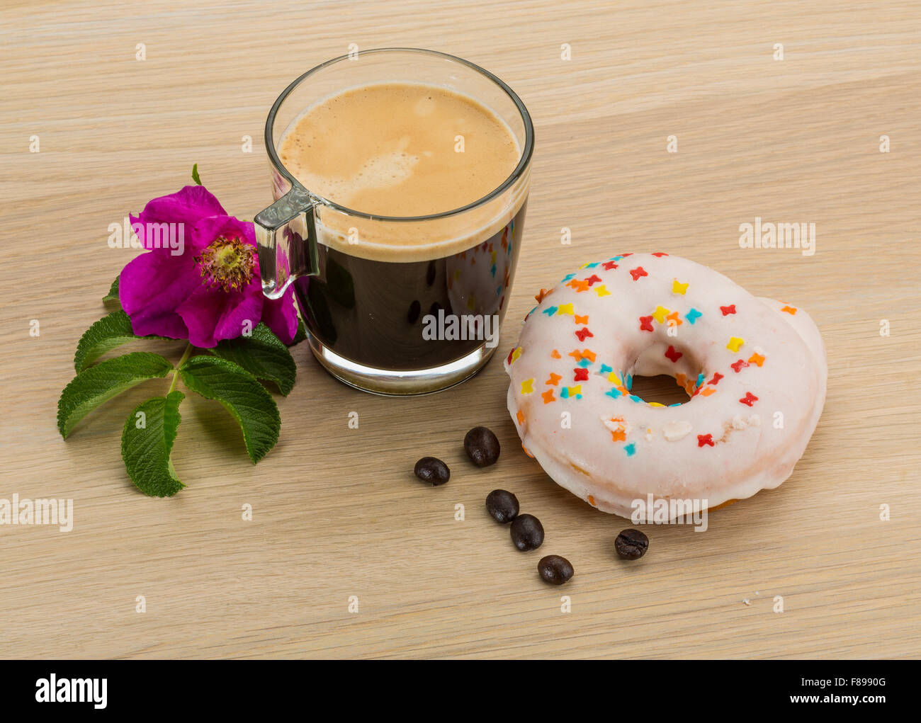 Glazed donuts with coffee on the desk Stock Photo - Alamy