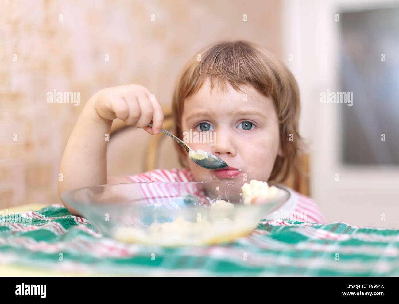 child eats with spoon in home Stock Photo - Alamy