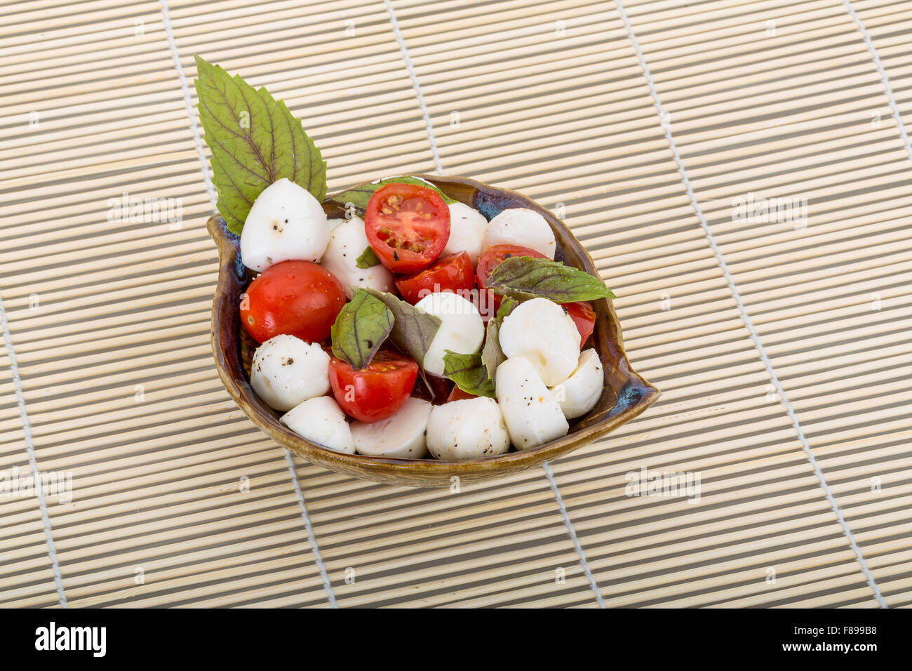 Famous italian caprese salad with fresh basil leaves Stock Photo - Alamy