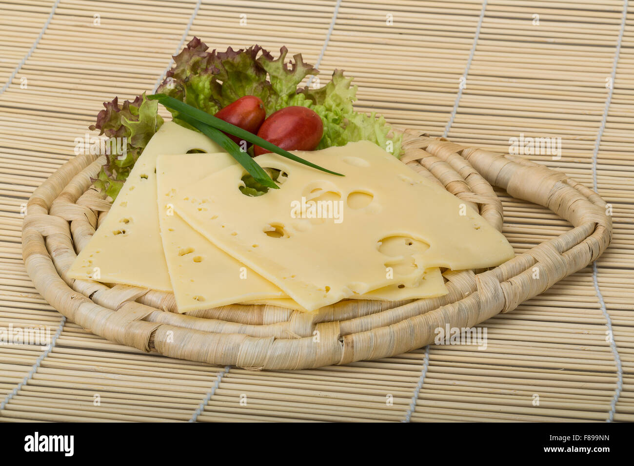 Maasdam cheese slices on the wooden background Stock Photo - Alamy