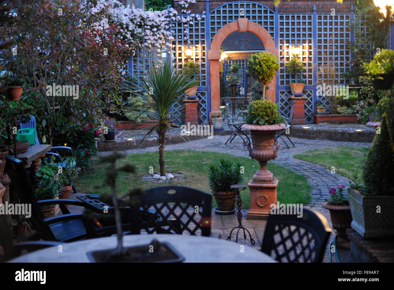 Back garden with trellis and mirror Stock Photo - Alamy