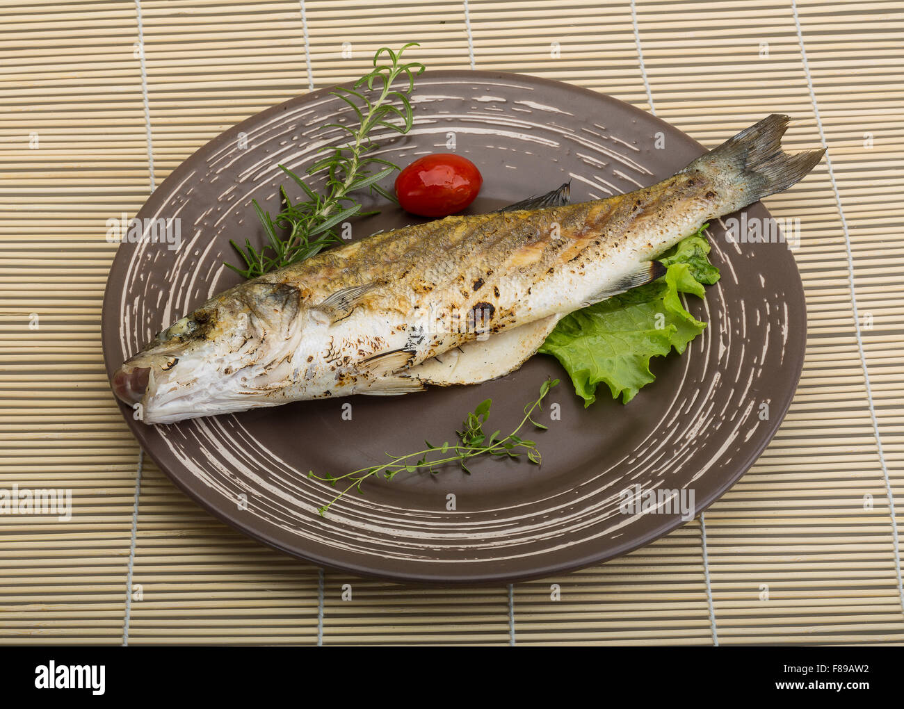 Grilled seabass fish - with rosemary and thyme Stock Photo - Alamy