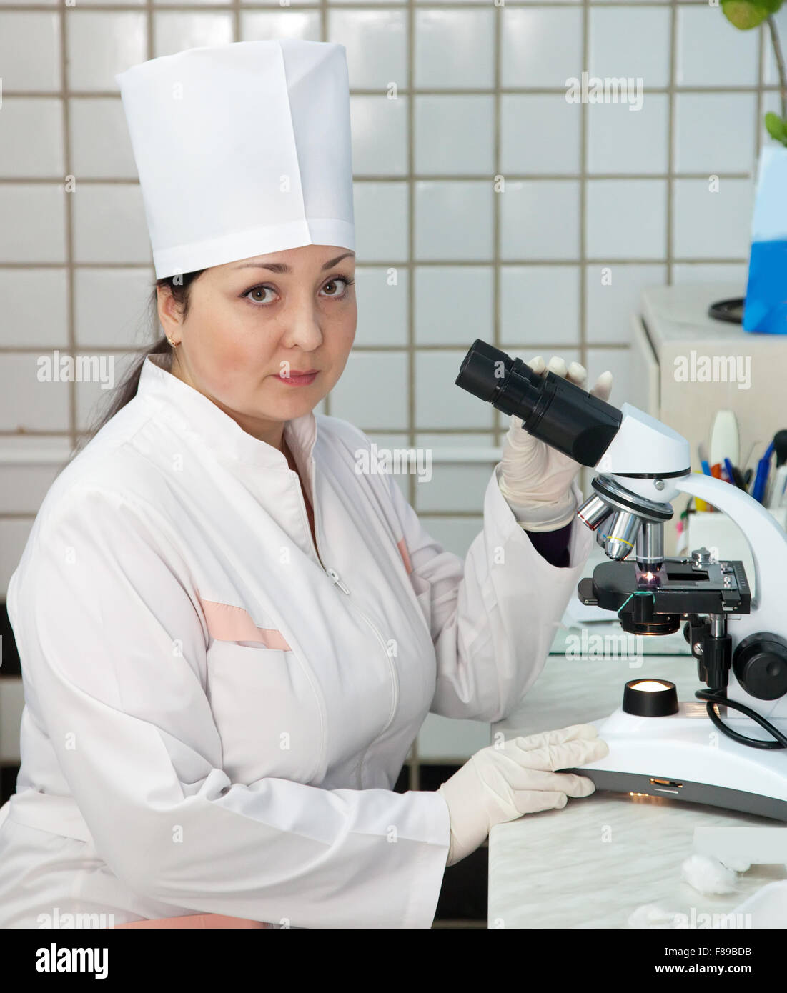 Woman doctor with microscope in lab Stock Photo - Alamy