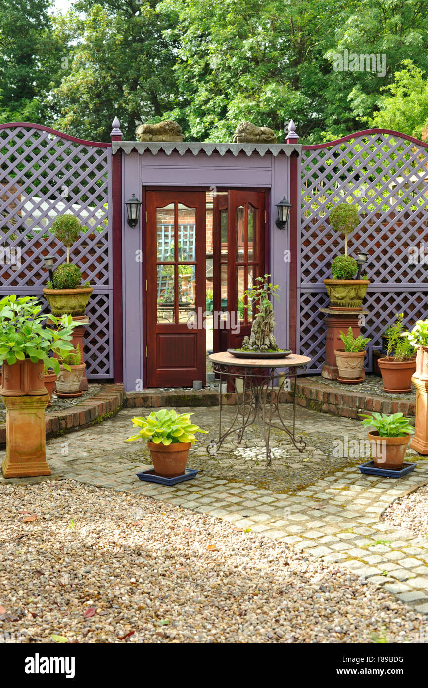 Trellis and fake doorway with mirror in Garden Stock Photo - Alamy