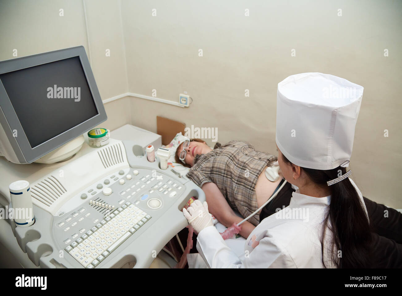 Female doctor making ultrasound investigation in medical clinic Stock ...