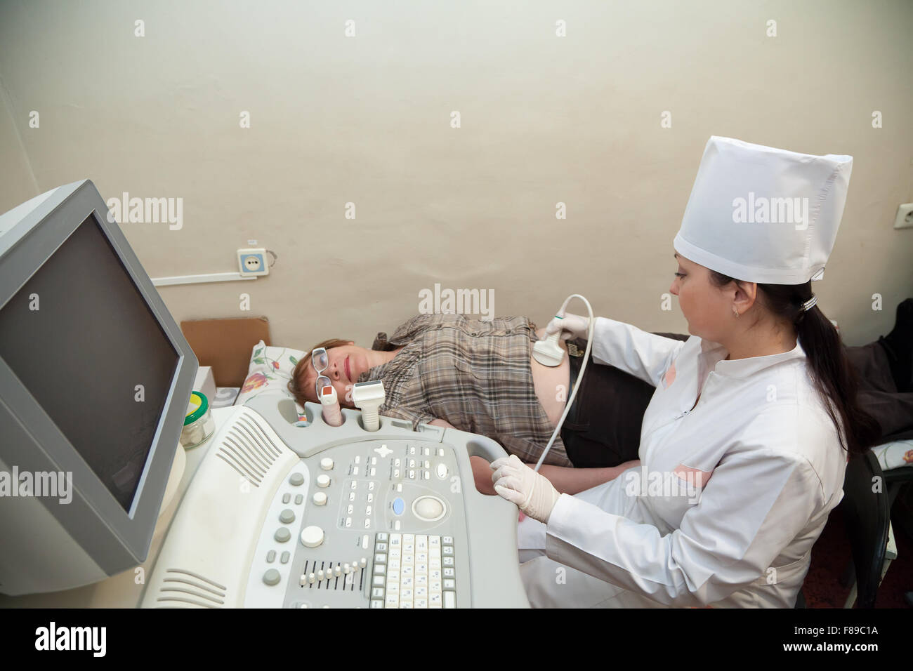 Female doctor making ultrasound investigation in medical clinic Stock ...