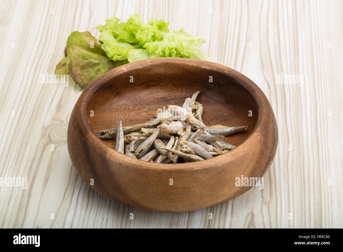 Dries anchovy - small fishes in the bowl Stock Photo - Alamy