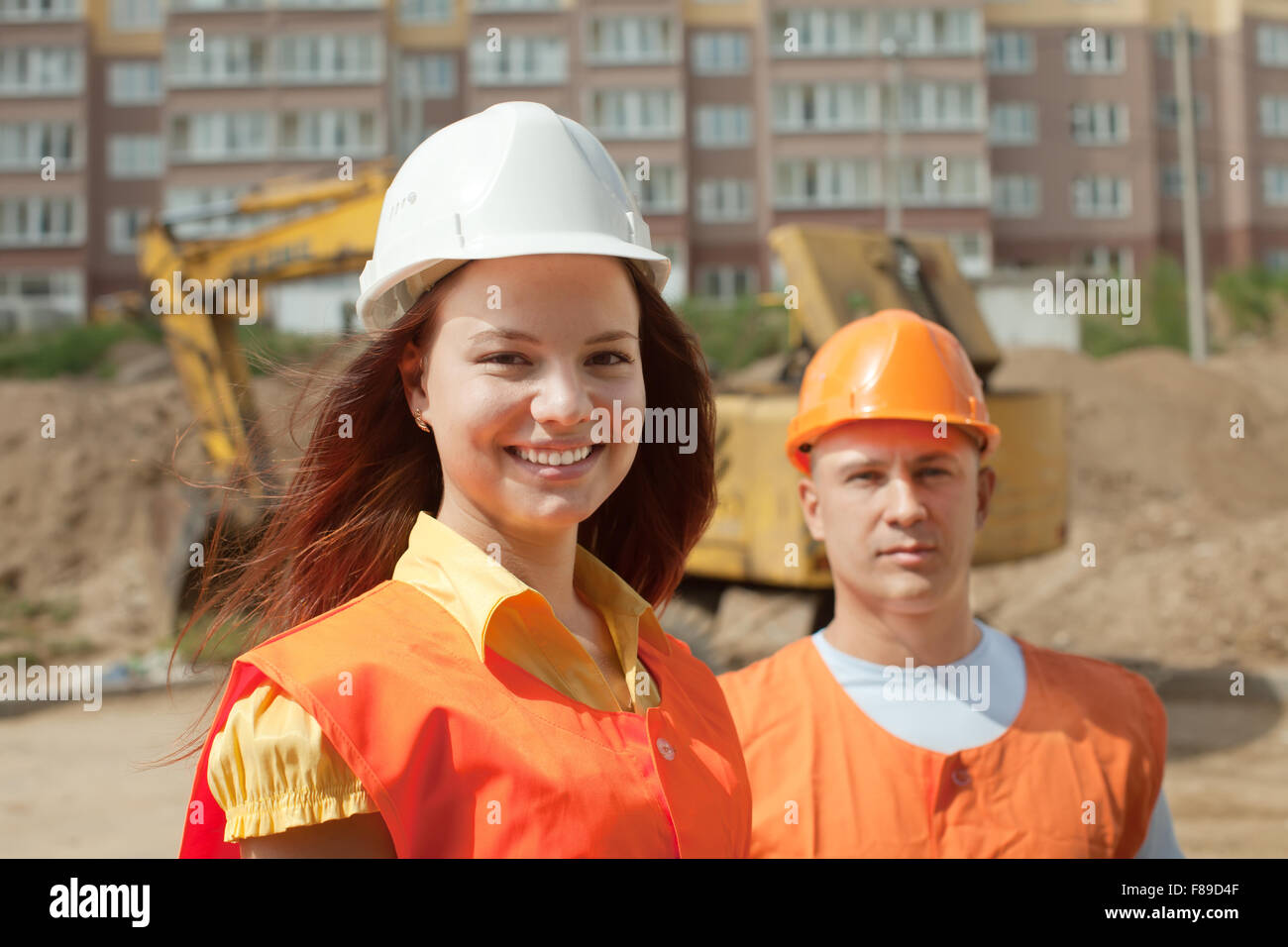 Portrait of two builders works at construction site Stock Photo - Alamy