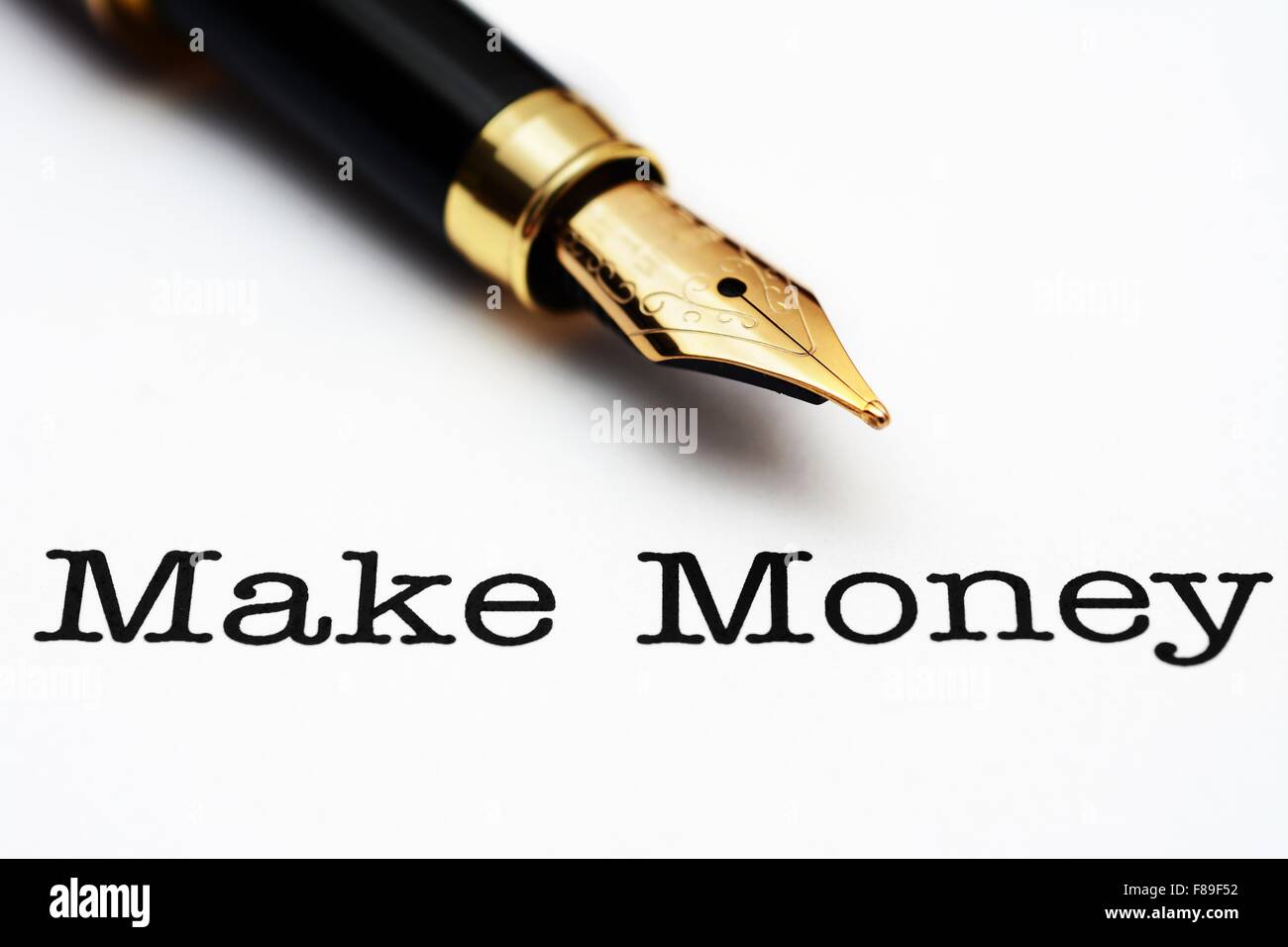 Fountain pen on make money text Stock Photo - Alamy
