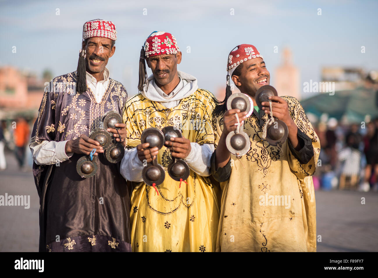 Three Gnawa musicians in traditional dress performing at Jemaa Stock ...