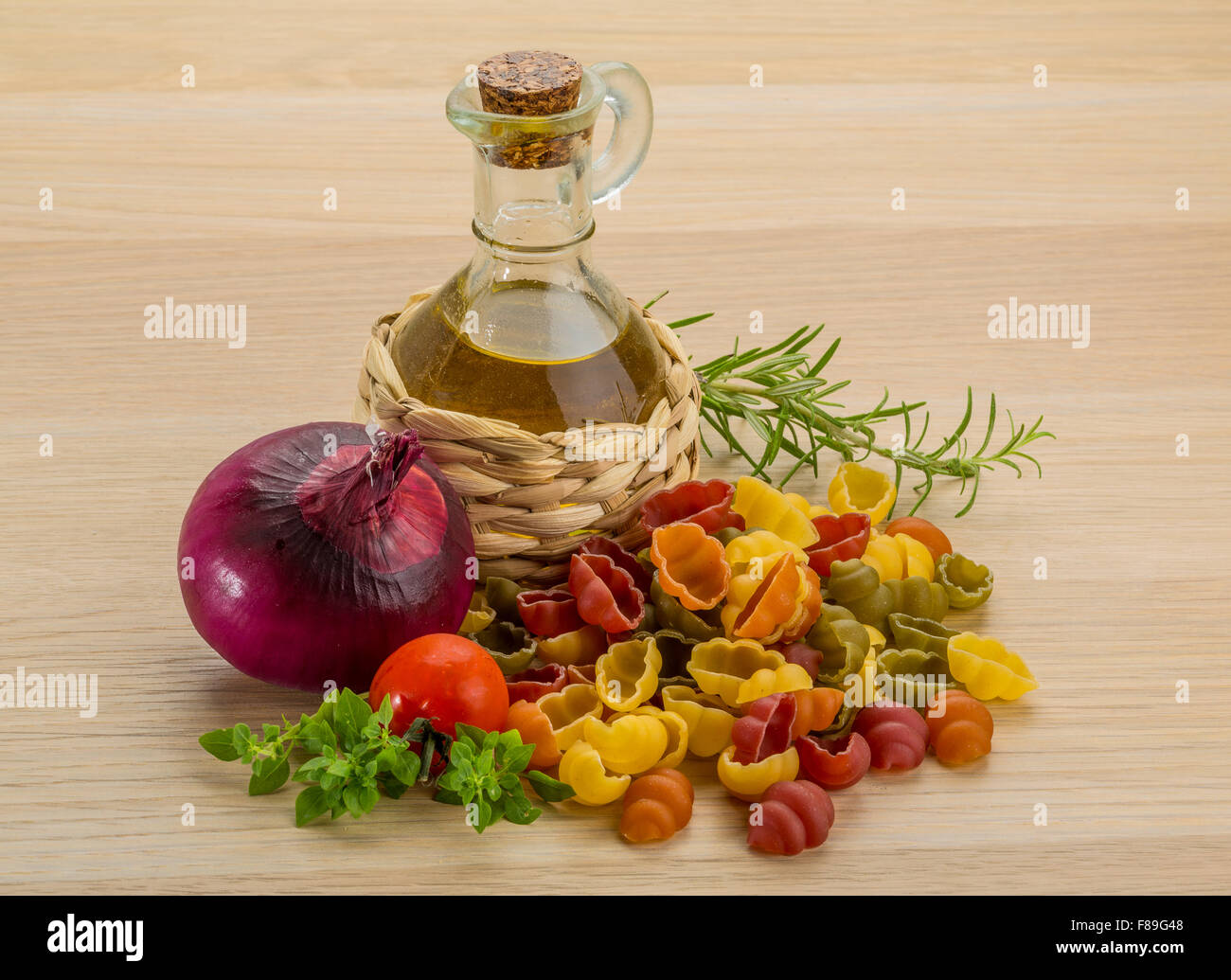 Raw macaroni - shell pasta with herbs Stock Photo - Alamy