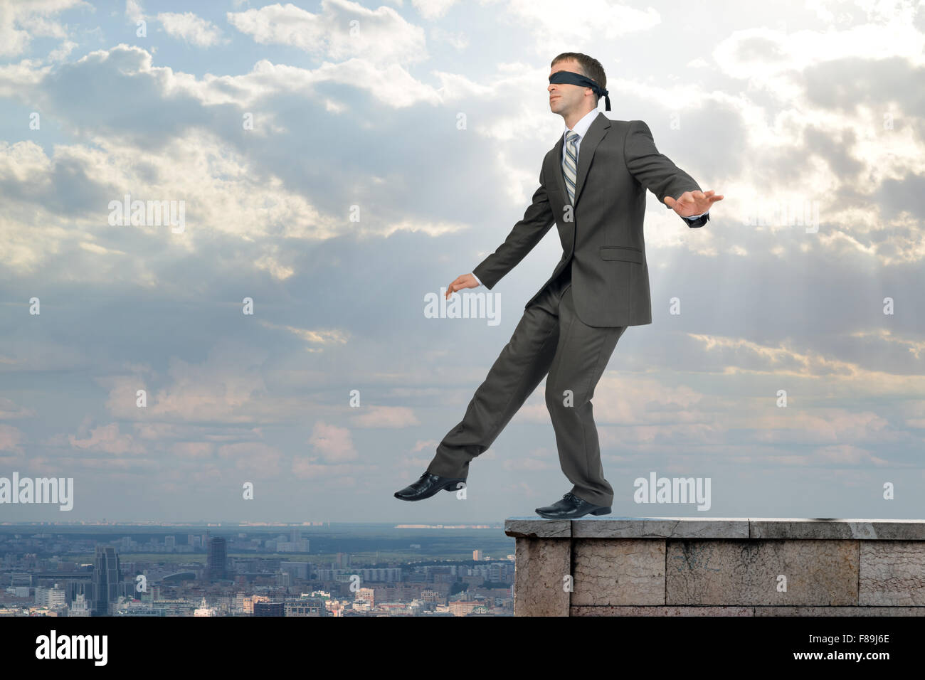 Man walking from edge of building roof Stock Photo - Alamy