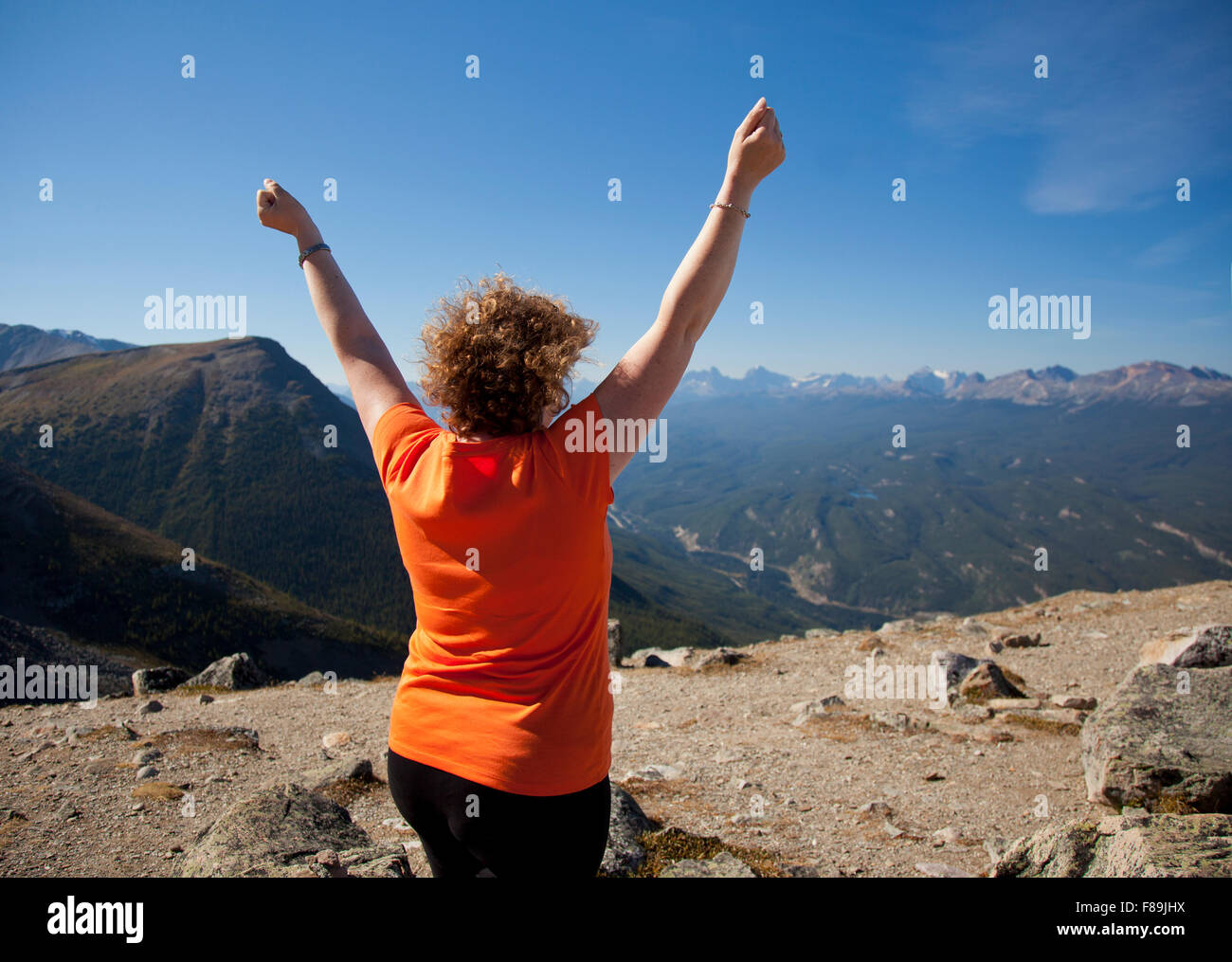 happy victorious woman celebrating on top of mountain Stock Photo - Alamy