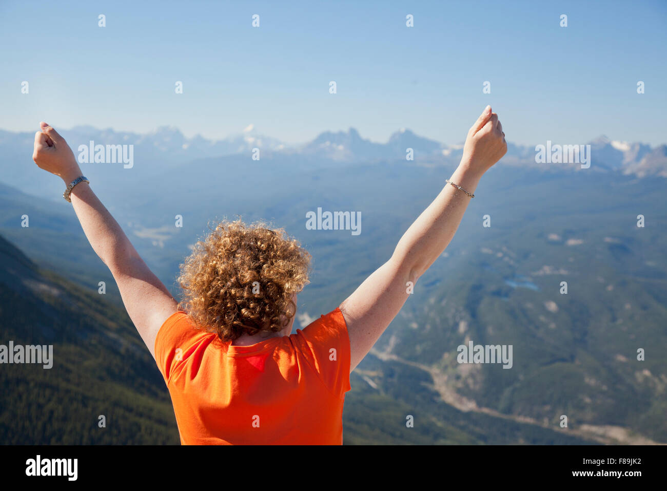 happy victorious woman celebrating on top of mountain Stock Photo - Alamy