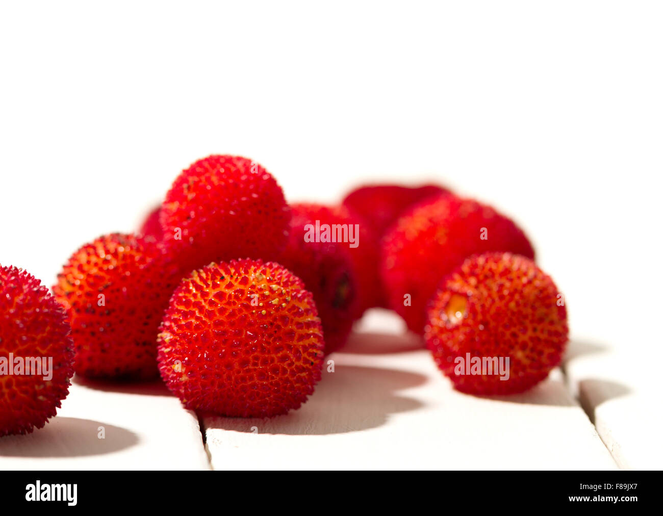 arbutus fruit over a table just collected Stock Photo - Alamy