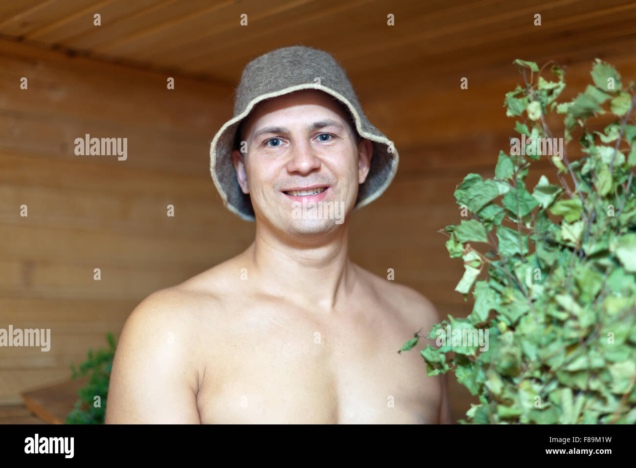 Man taking steam in wooden sauna Stock Photo - Alamy