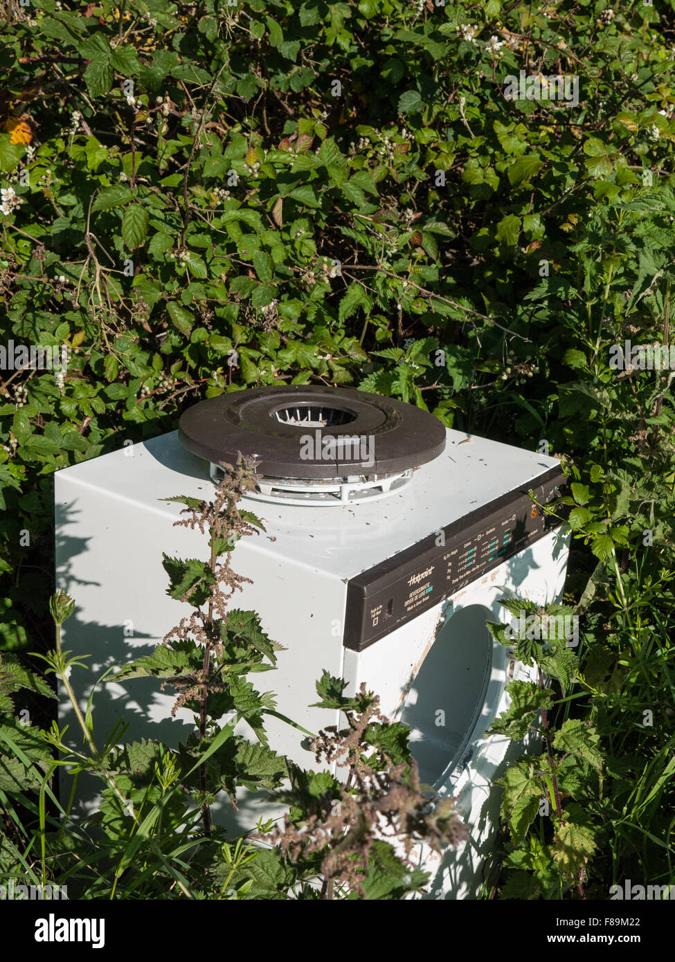 Fly tipping of old discarded tumble dryer, domestic appliance Stock ...