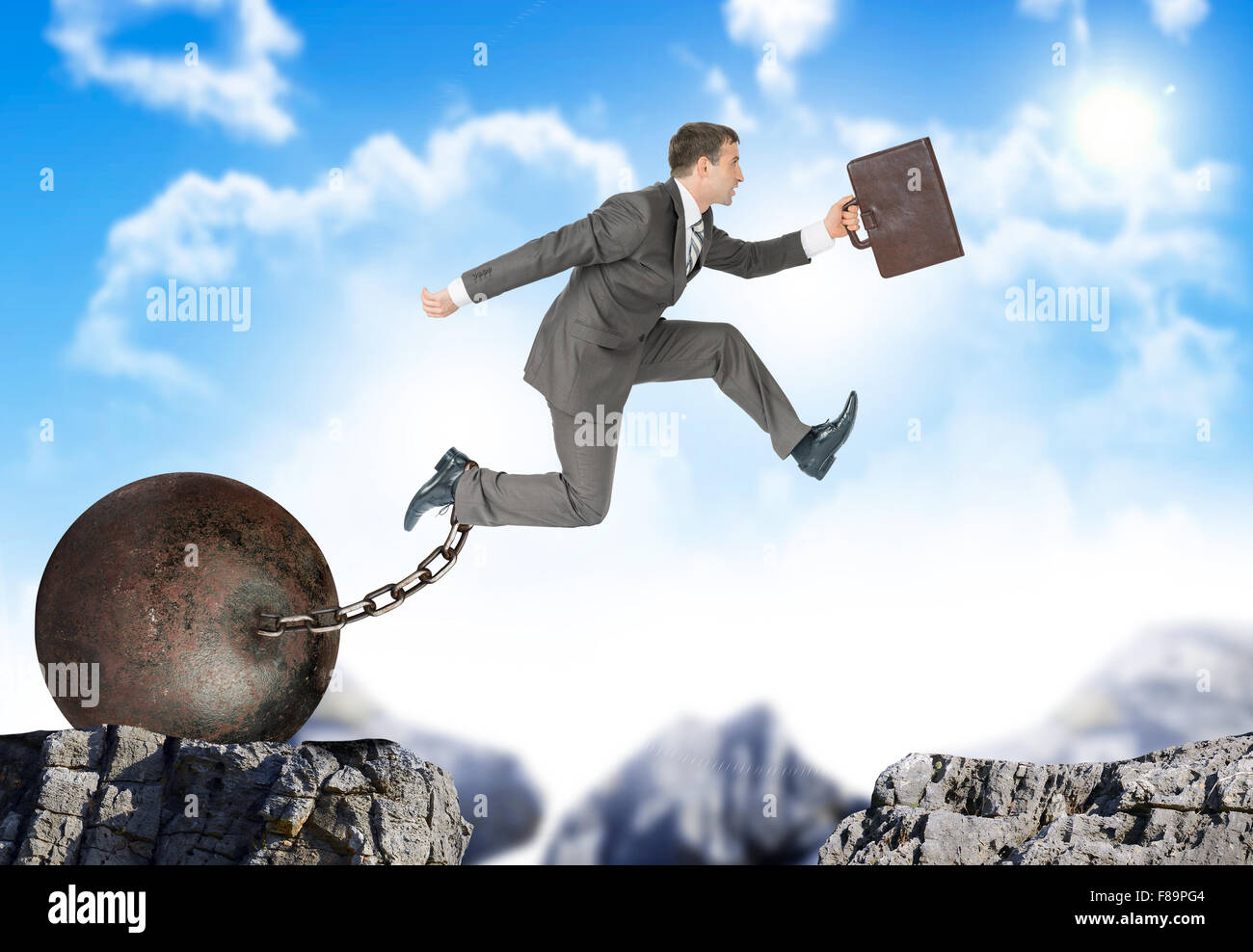 Businessman hopping over bottomless pit Stock Photo - Alamy