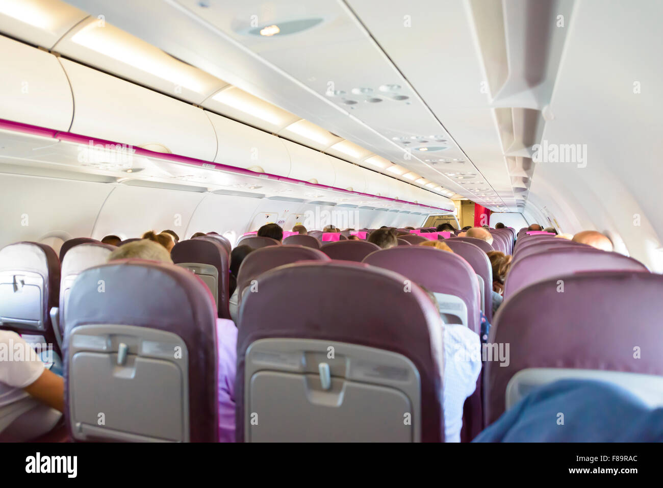 Interior of the passenger airplane with passengers on seats Stock Photo ...