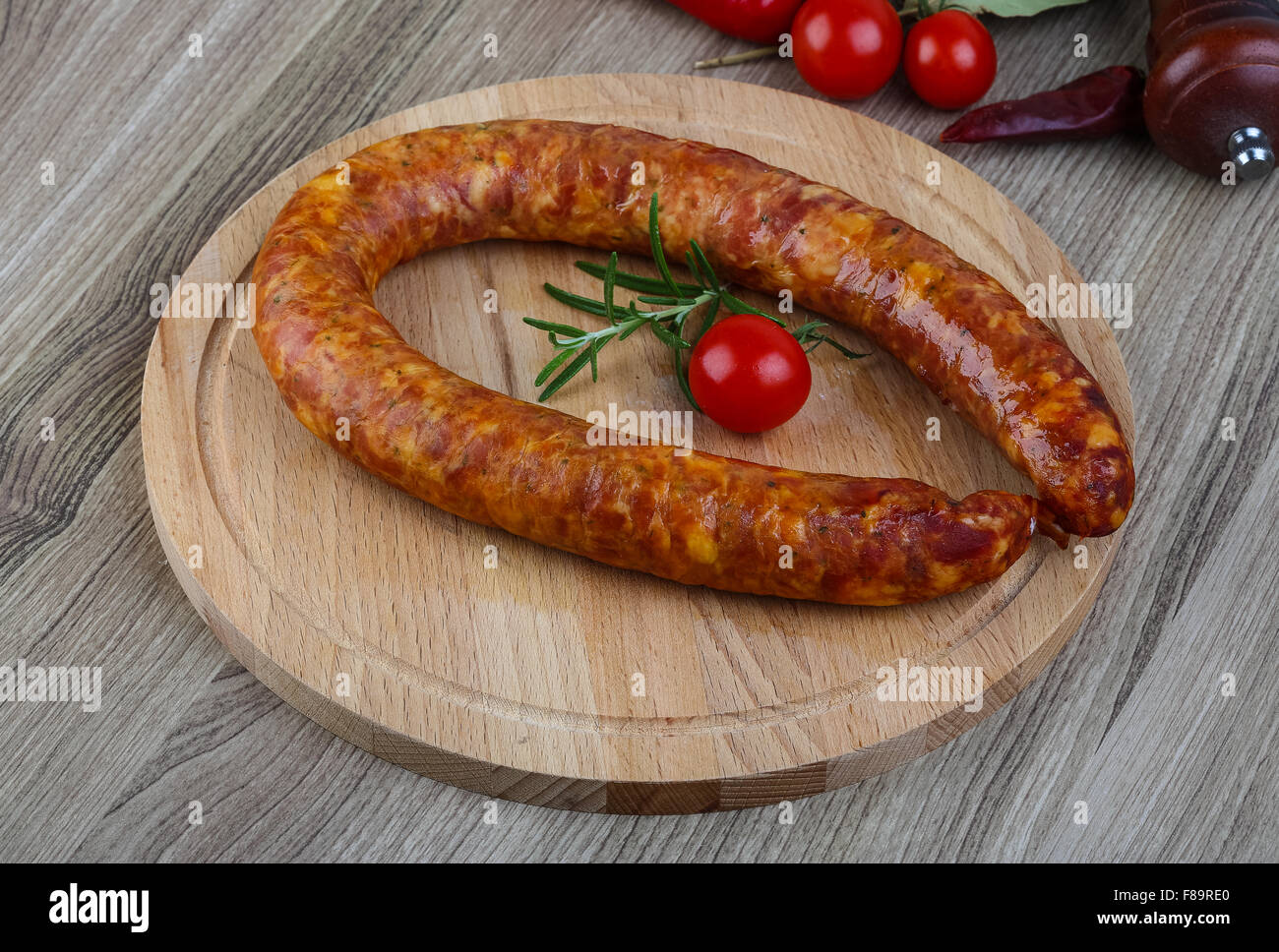 Sausage ring with rosemary and pepper on the wood background Stock ...