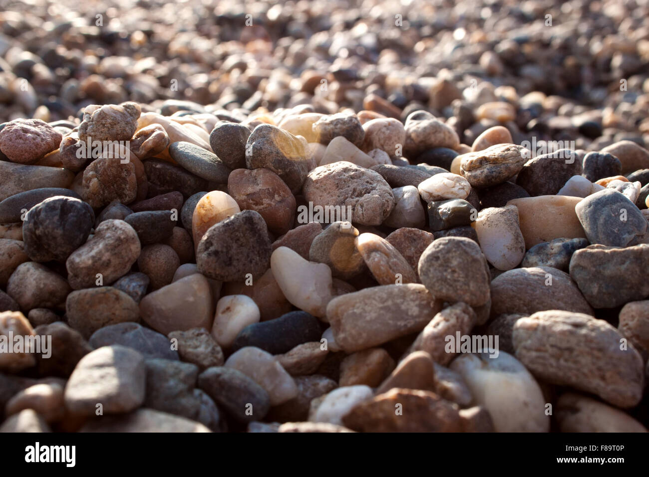 Abstract background with small smooth river pebbles Stock Photo - Alamy