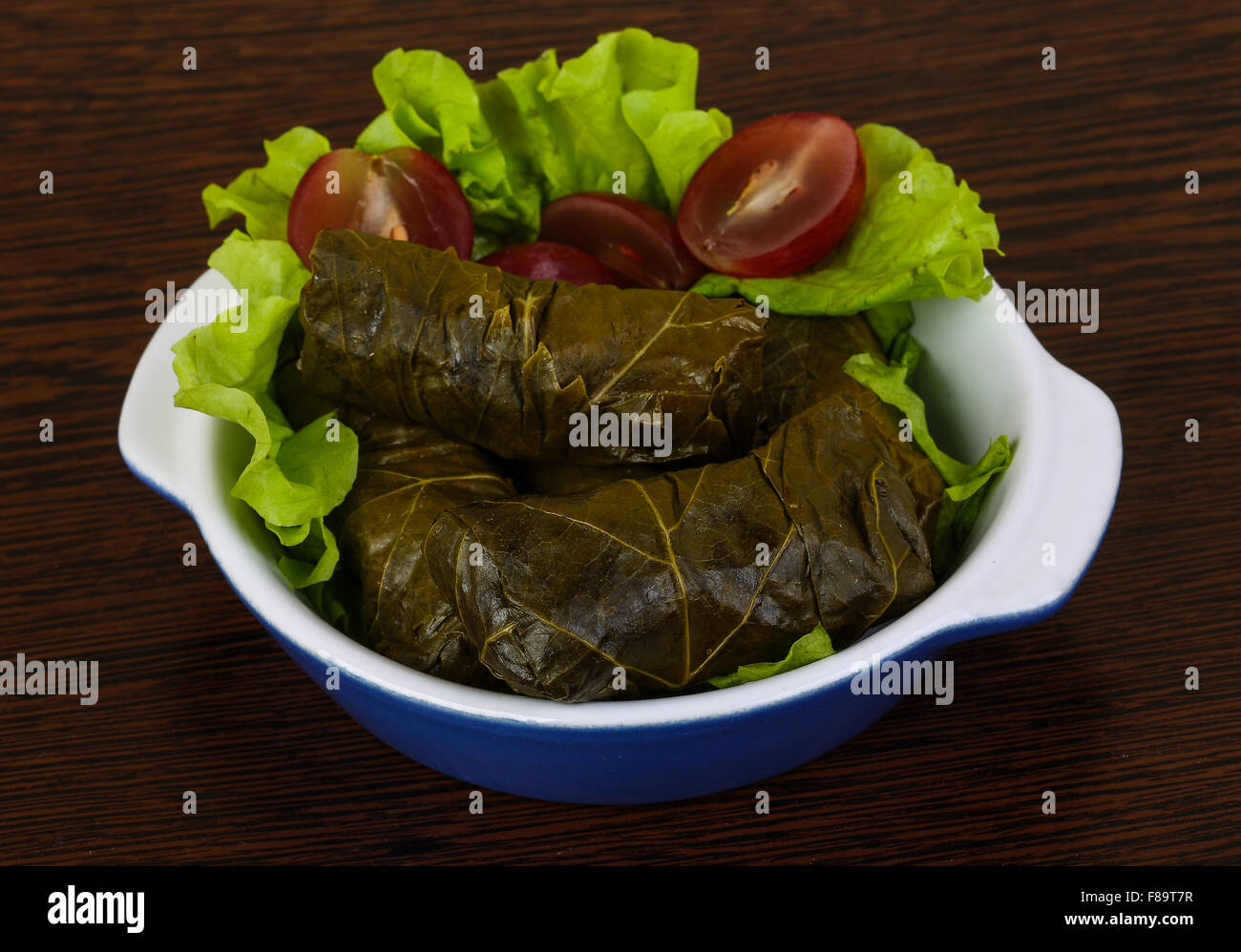 Dolma - minced meat in grape leaves with salad Stock Photo - Alamy