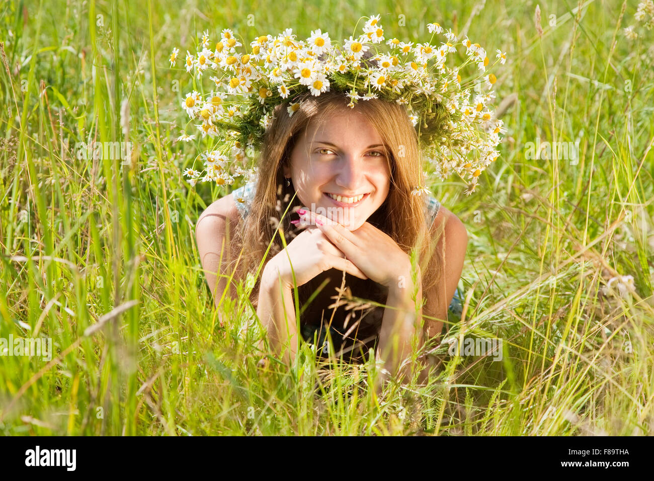 long-haired girl in flower chaplet in grass Stock Photo - Alamy