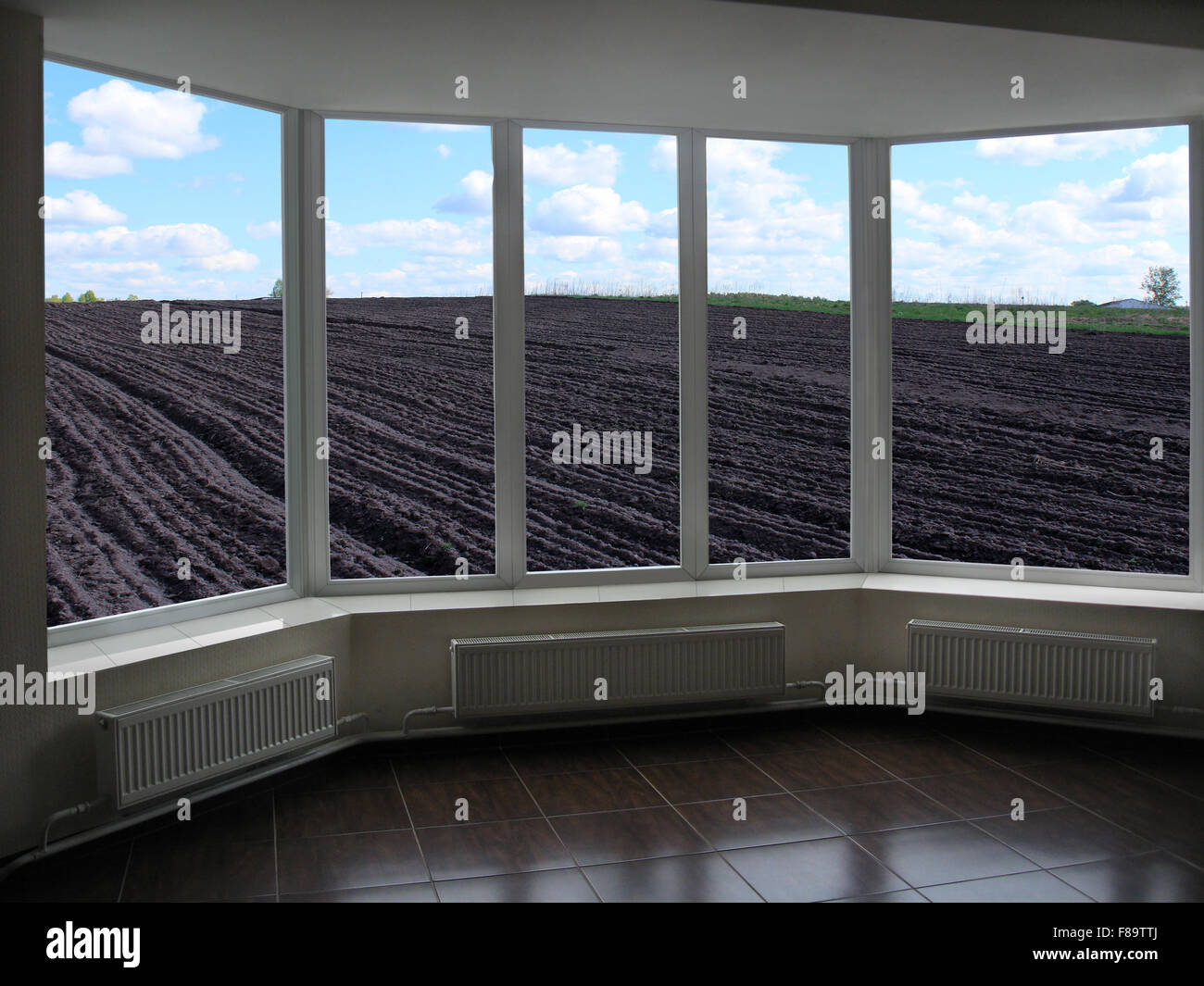 plastic windows overlooking plowed land ready for planting in the ...
