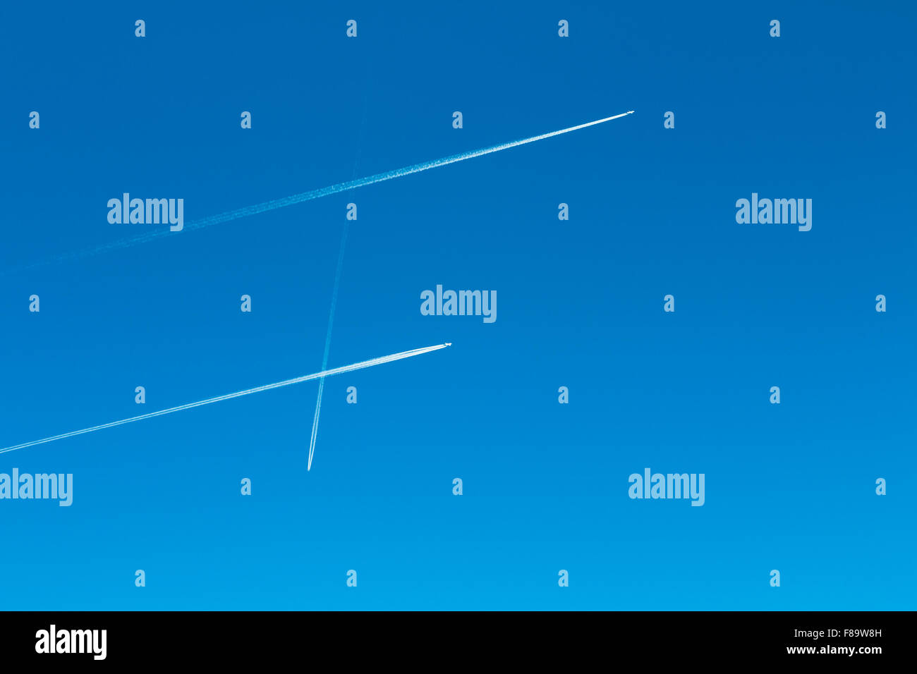 Three jet trails with two parellel trails and one plane crossing Stock ...