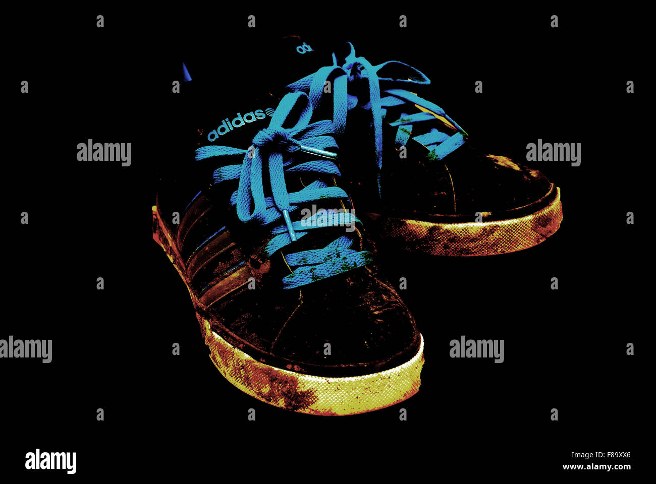 muddy trainers,trainers,mud,black background,blue laces Stock Photo - Alamy
