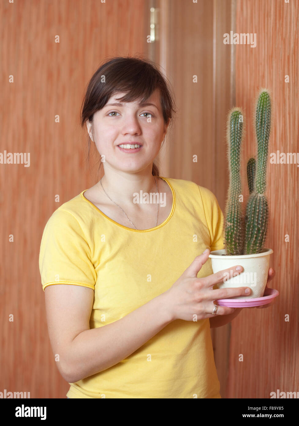 Girl with cactus in the pots at her home Stock Photo - Alamy