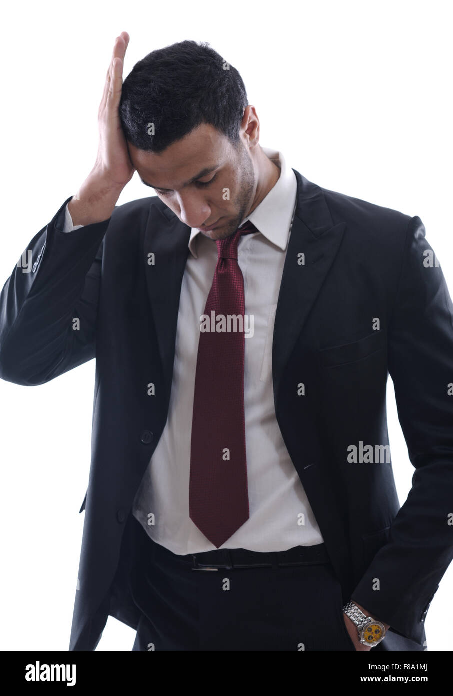 Portrait of a young business man looking depressed from work isolated ...
