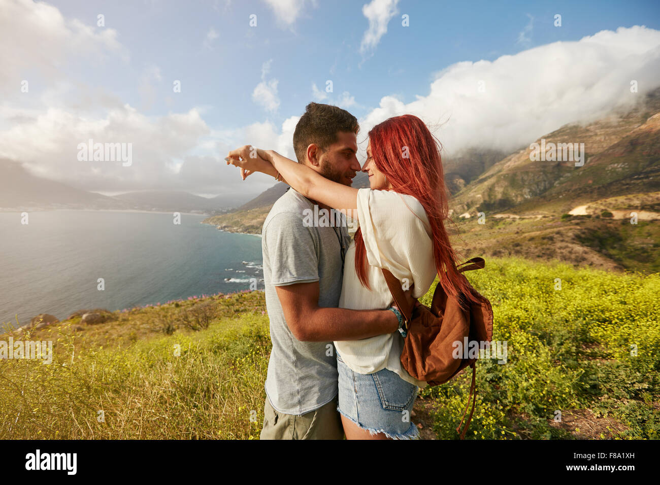 Side View Of Romantic Young Couple On Holidays Man And Woman Embracing