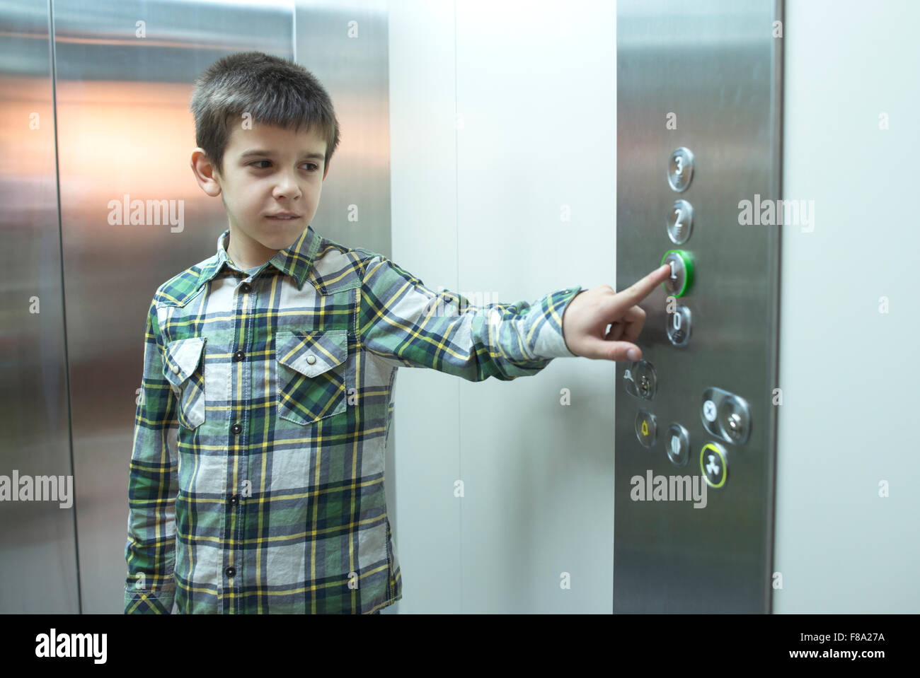 Child pushed a button in an elevator Stock Photo - Alamy