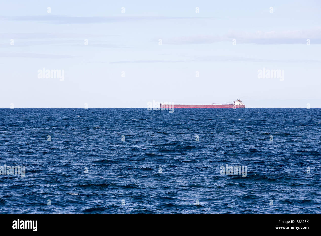 Great Lakes ore boat on the horizon with copy space if needed. Horizon ...