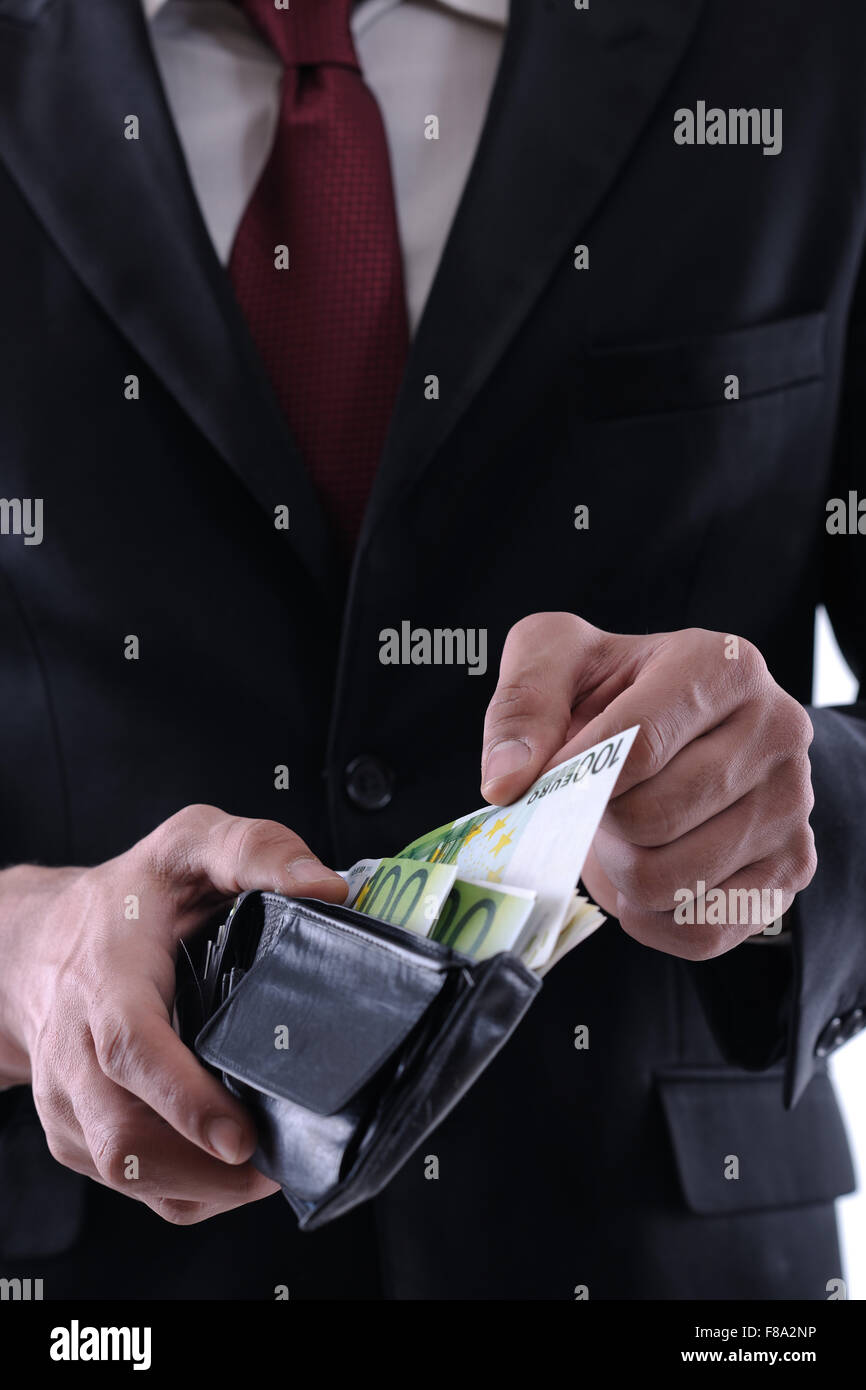 Portrait of a business man holding and catch falling money bills ...