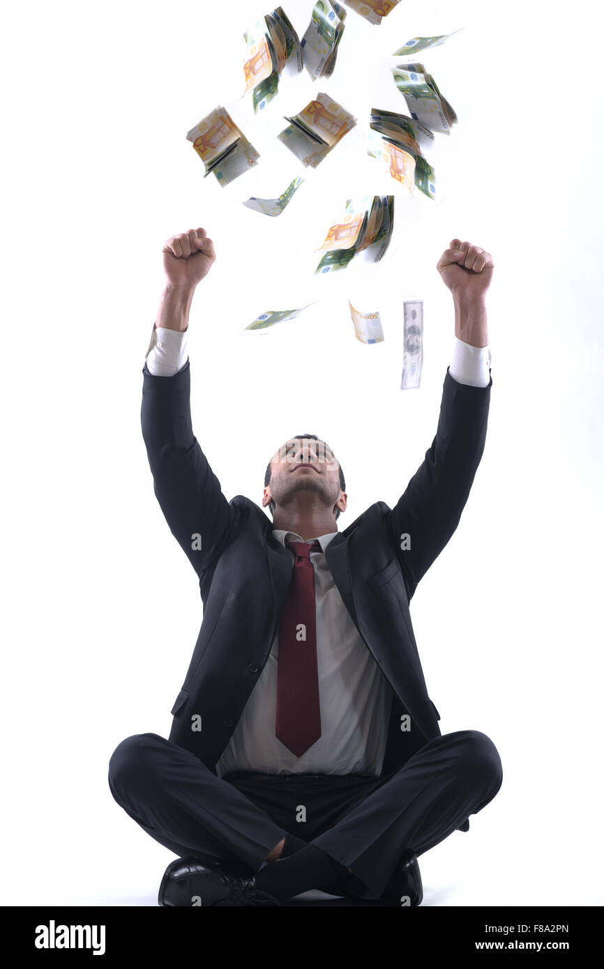 Portrait of a business man holding and catch falling money bills ...