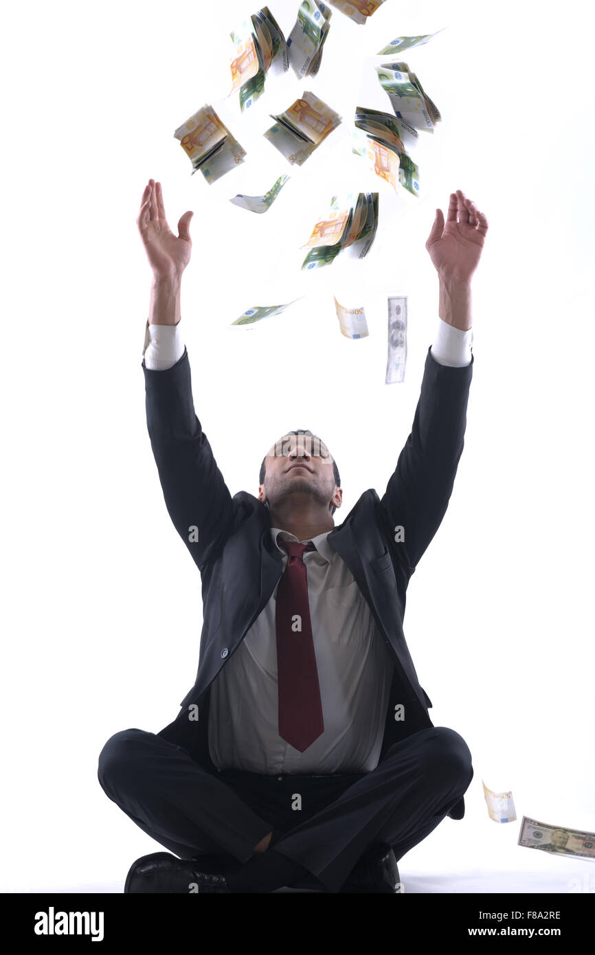 Portrait of a business man holding and catch falling money bills ...