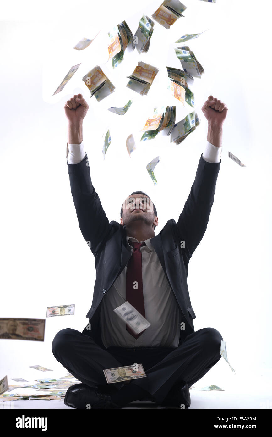 Portrait of a business man holding and catch falling money bills ...